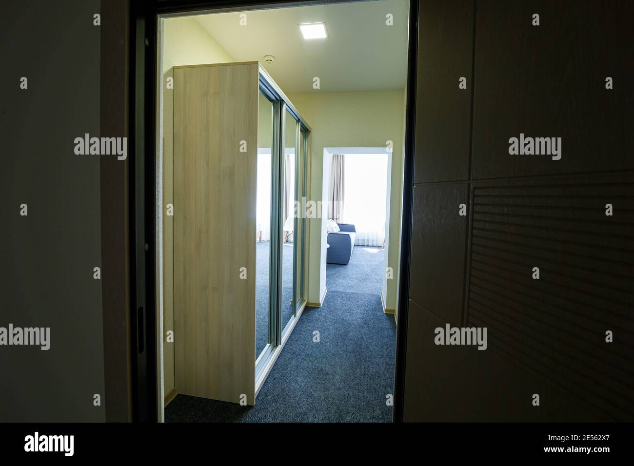 Long bright entrance hall with doors in a new hotel with wardrobe Stock ...