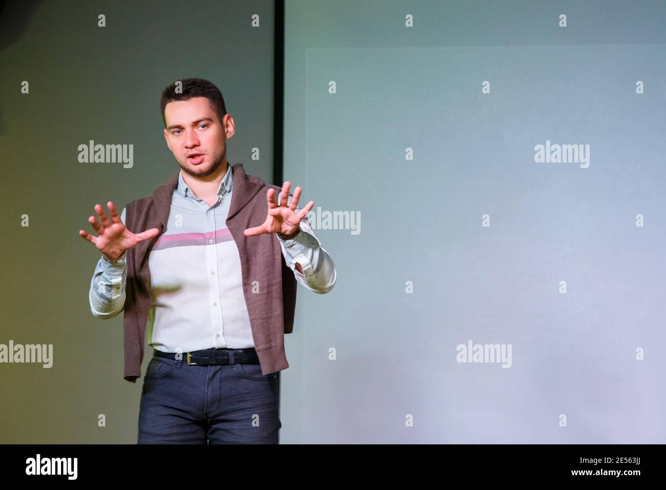 Successful male speaker conducts training. A businessman is giving a ...