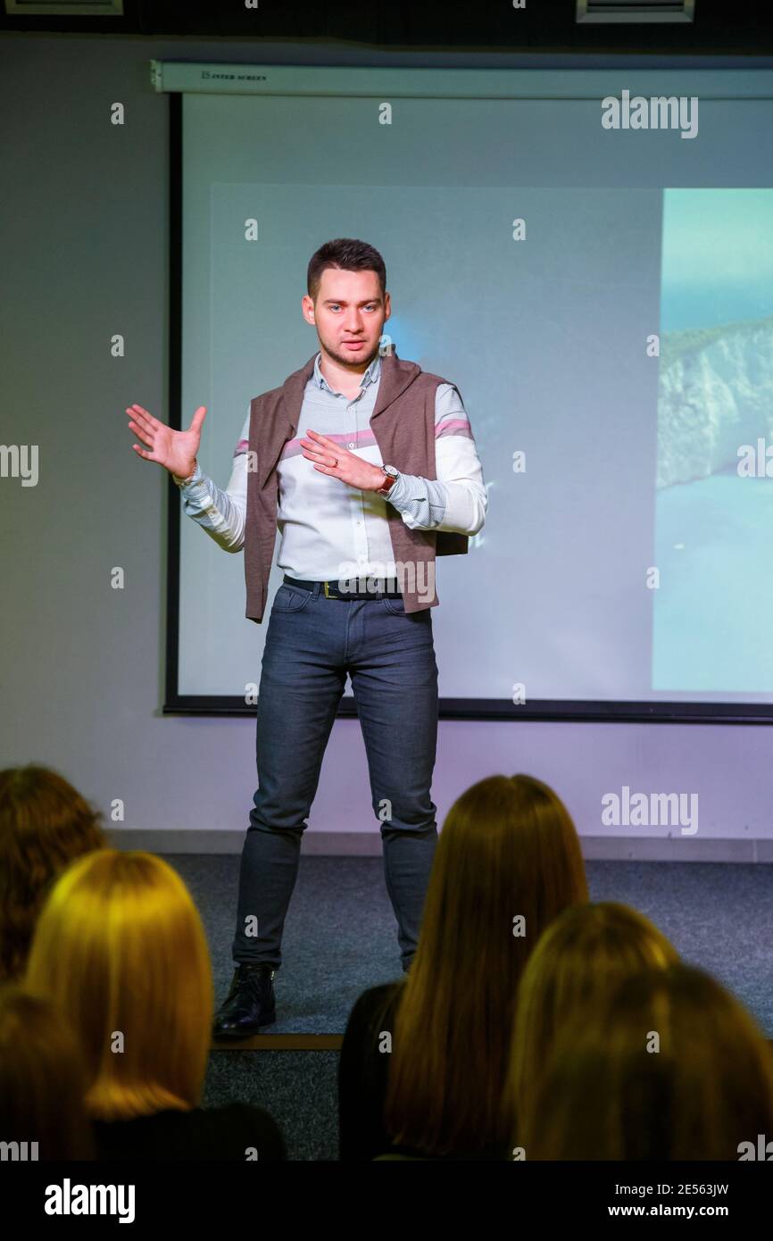 Successful male speaker conducts training. A businessman is giving a ...