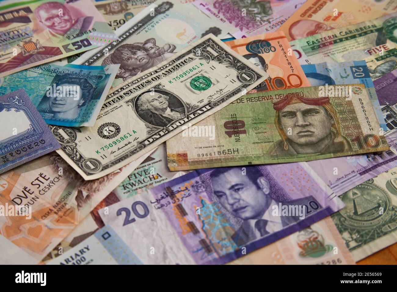 High angle shot of different cash bills on the table with a blurry ...
