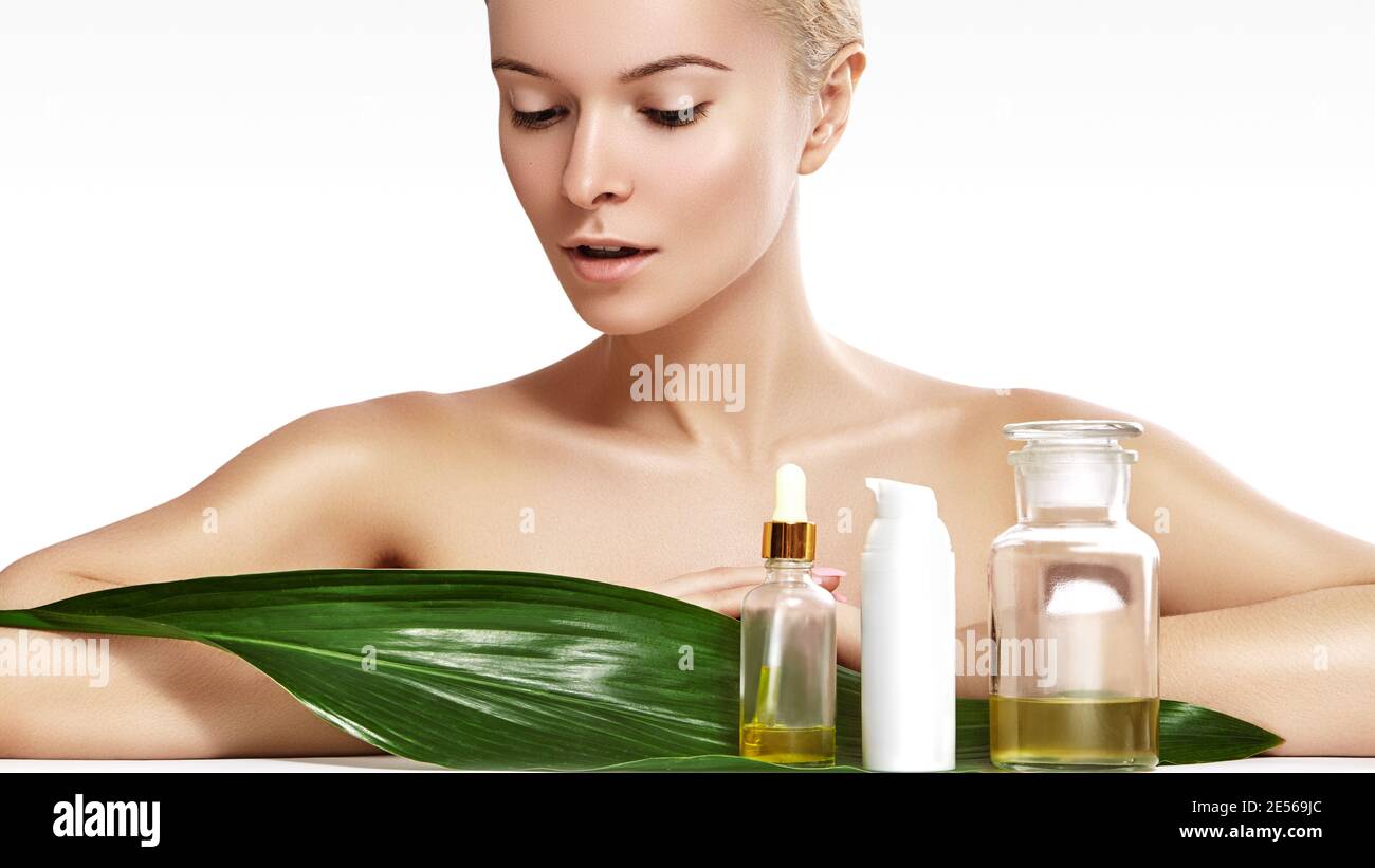 Beautiful woman applies Organic Cosmetic and oils for Beauty. Spa and ...