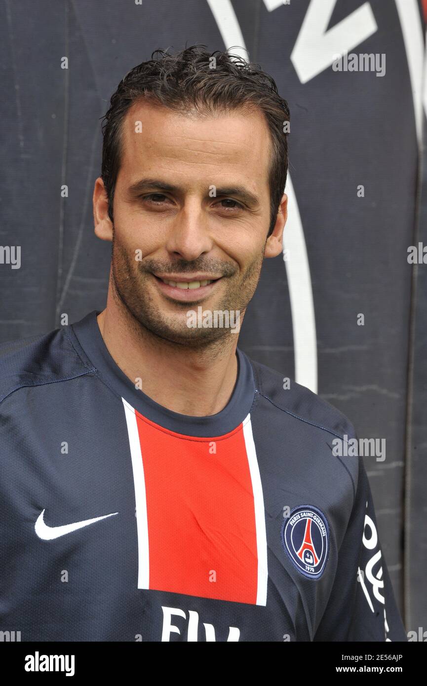 French player Ludovic Giuly poses with his new jersey after a press ...