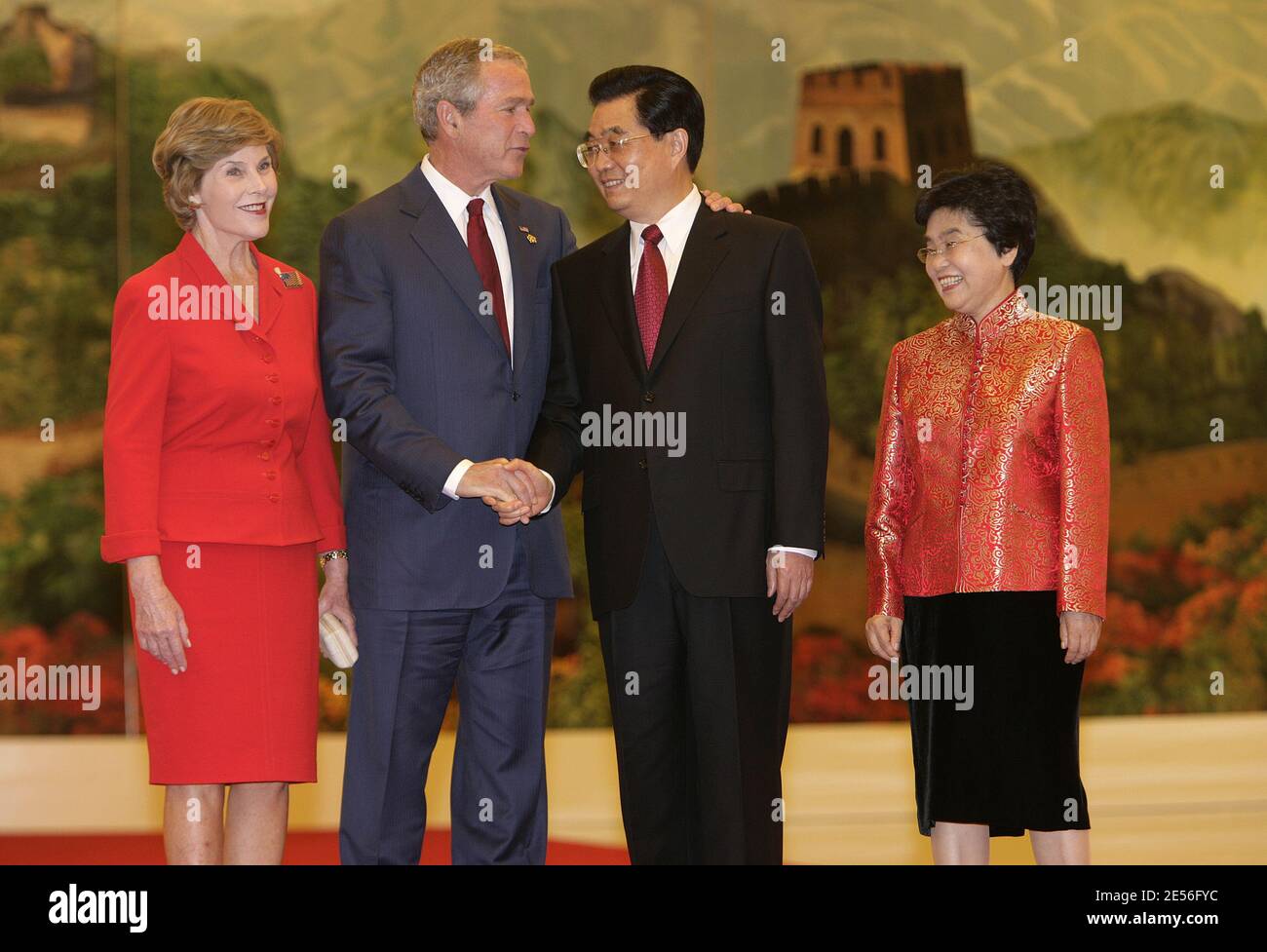US president George W. Bush and his wife Laura pose for a photo with ...