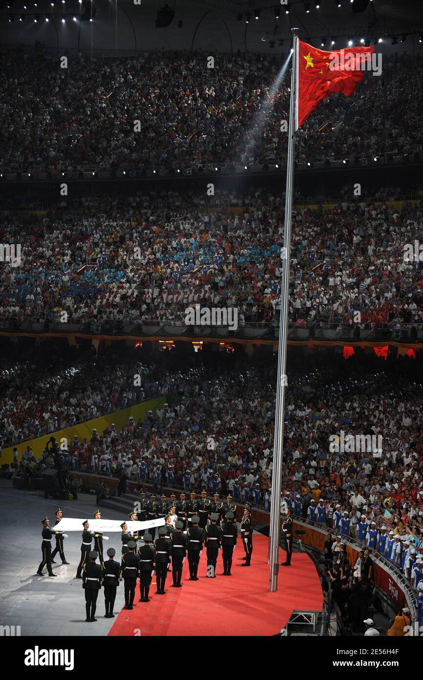 The Olympic flag is flown beside the Chinese flag during the Opening ...