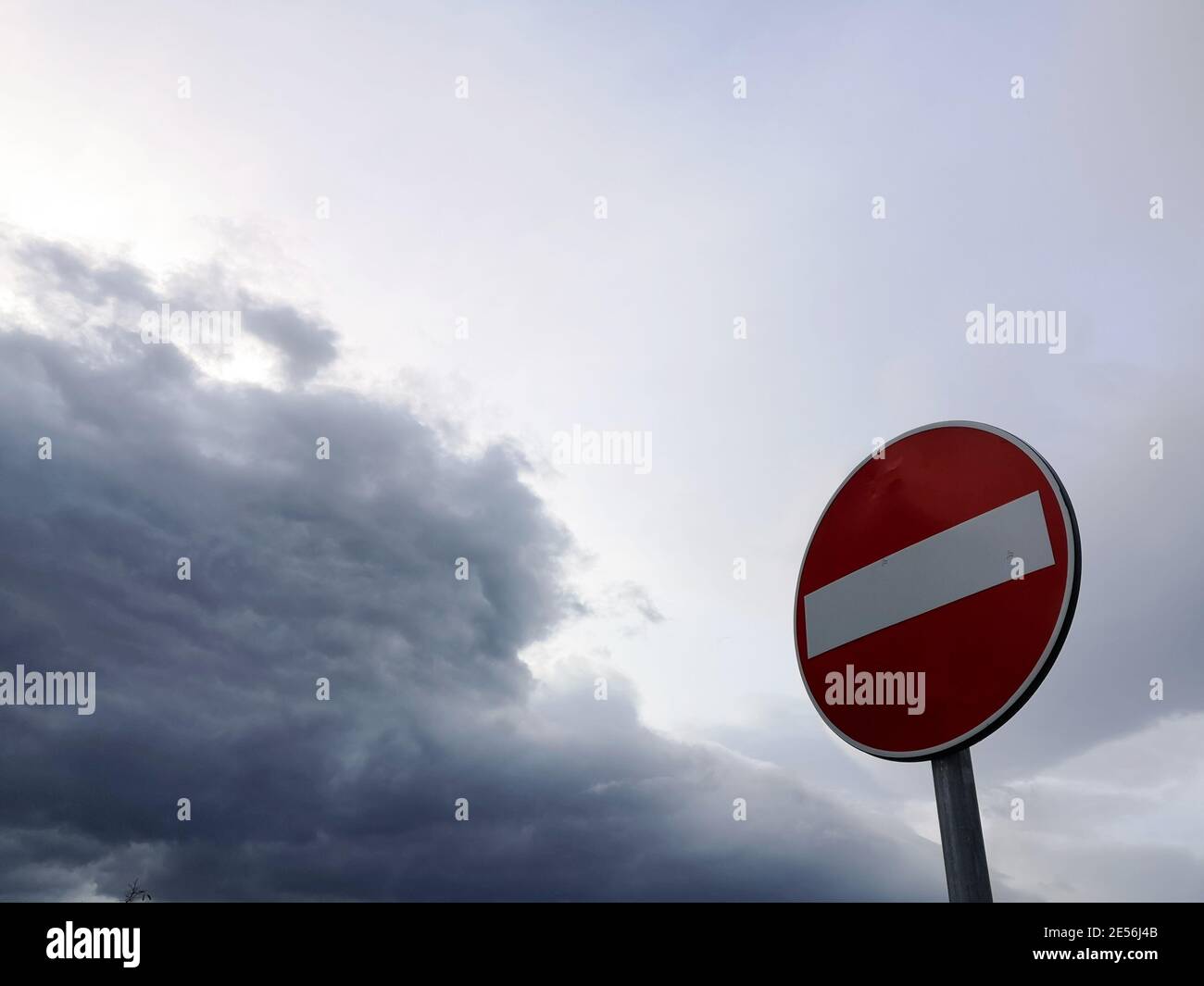 Low angle shot of a round stop sign under a gray cloudy sky Stock Photo ...