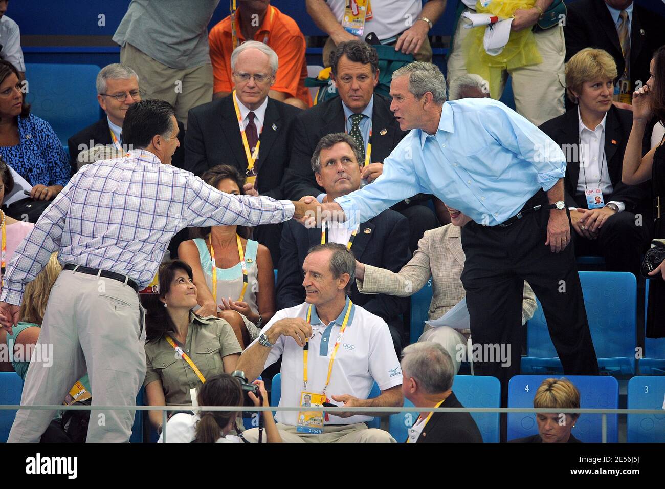 US president George W Bush shakes hands with Mitt Romney at the ...