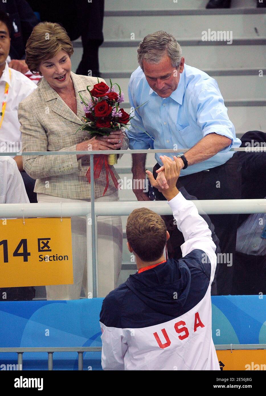 US president George W Bush and wife Laura shake hands with Olympic gold ...