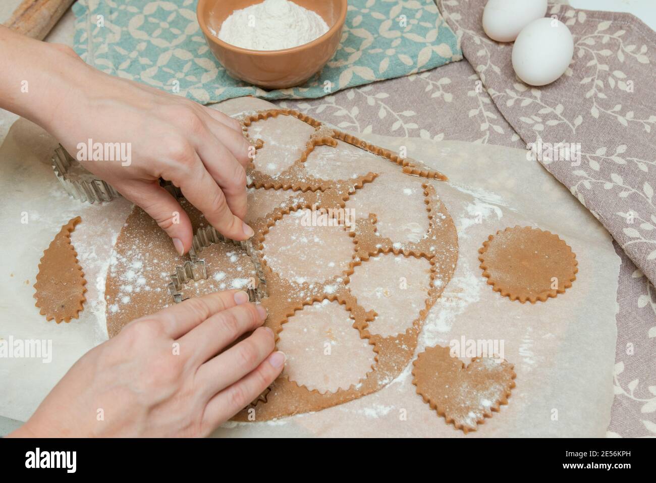 Process of cutting cookies by cookie cutters. Woman making by hands ...