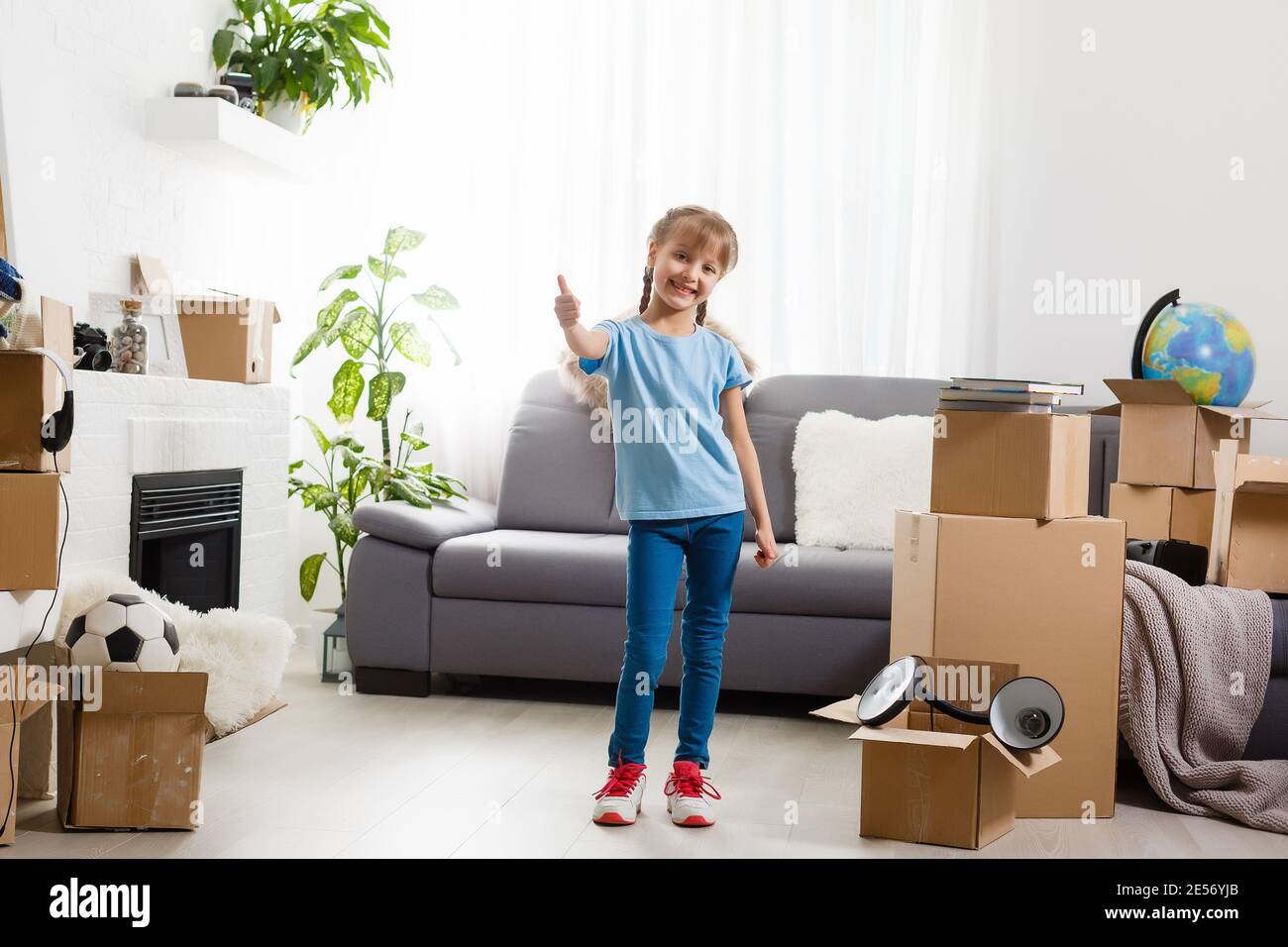 Little girl moving into new house, near cardboard box Stock Photo - Alamy