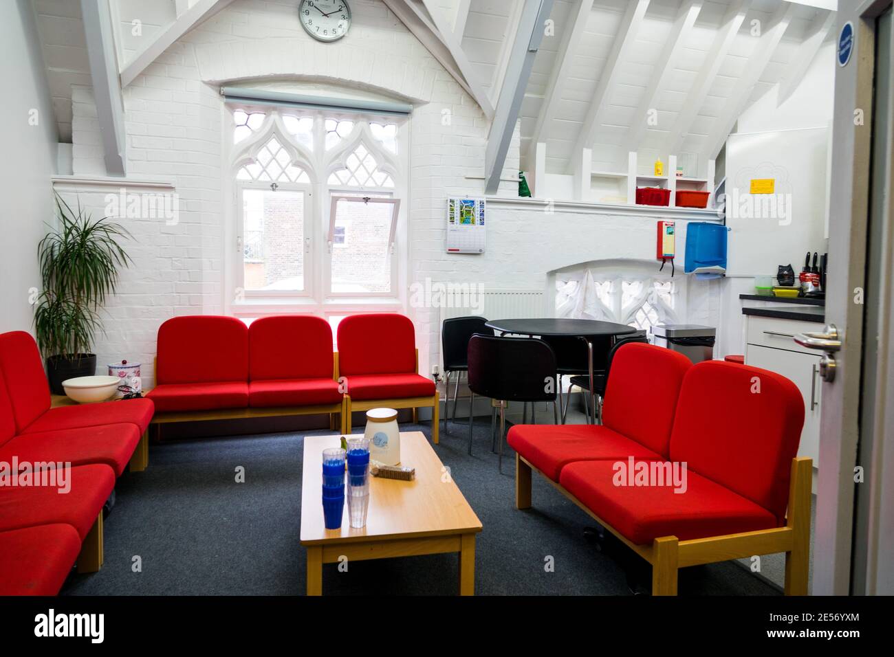 A primary school teacher staff room with seating area and biscuits on ...