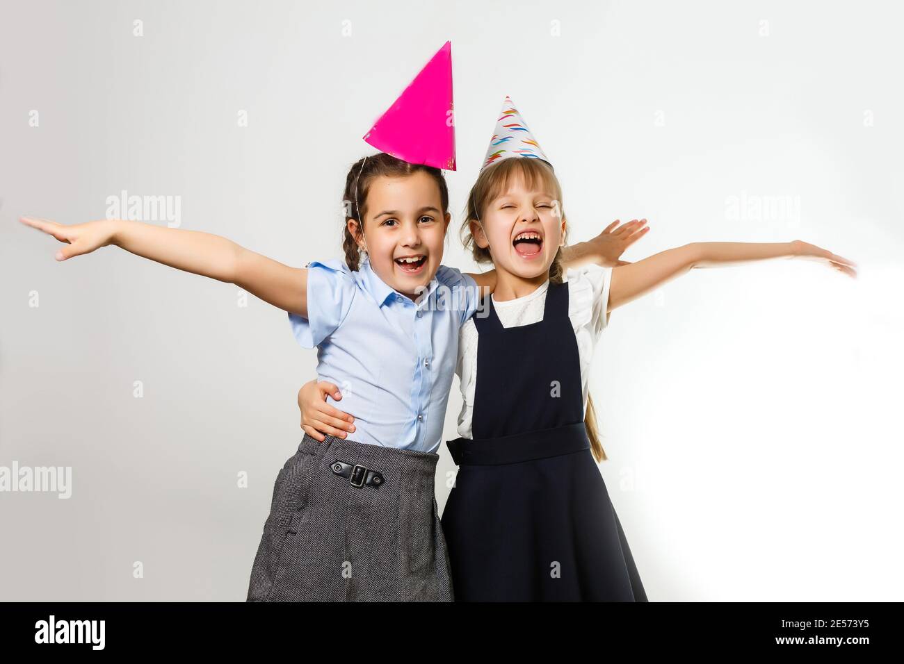 Two birthday girls in shirt blue school uniform dresses hat isolated on ...