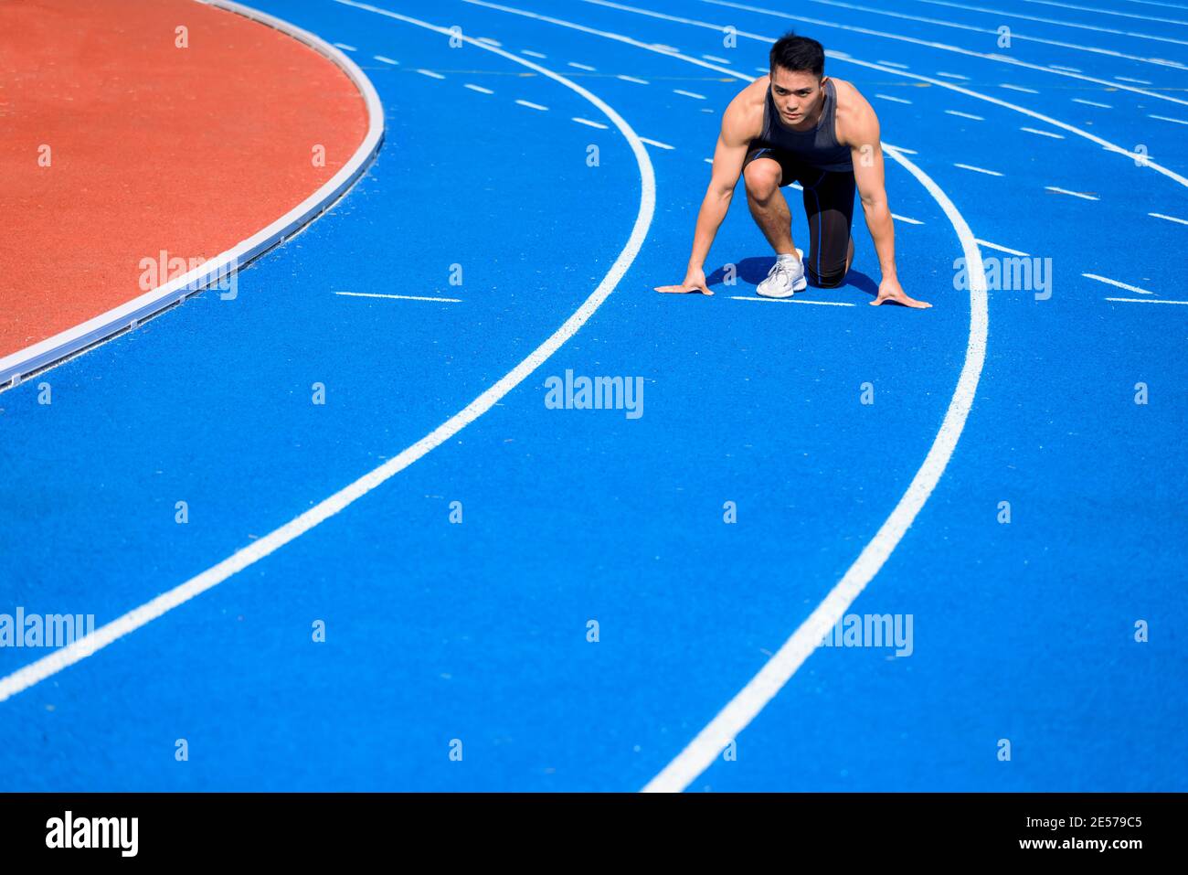 Male athlete on race track is ready to run Stock Photo - Alamy