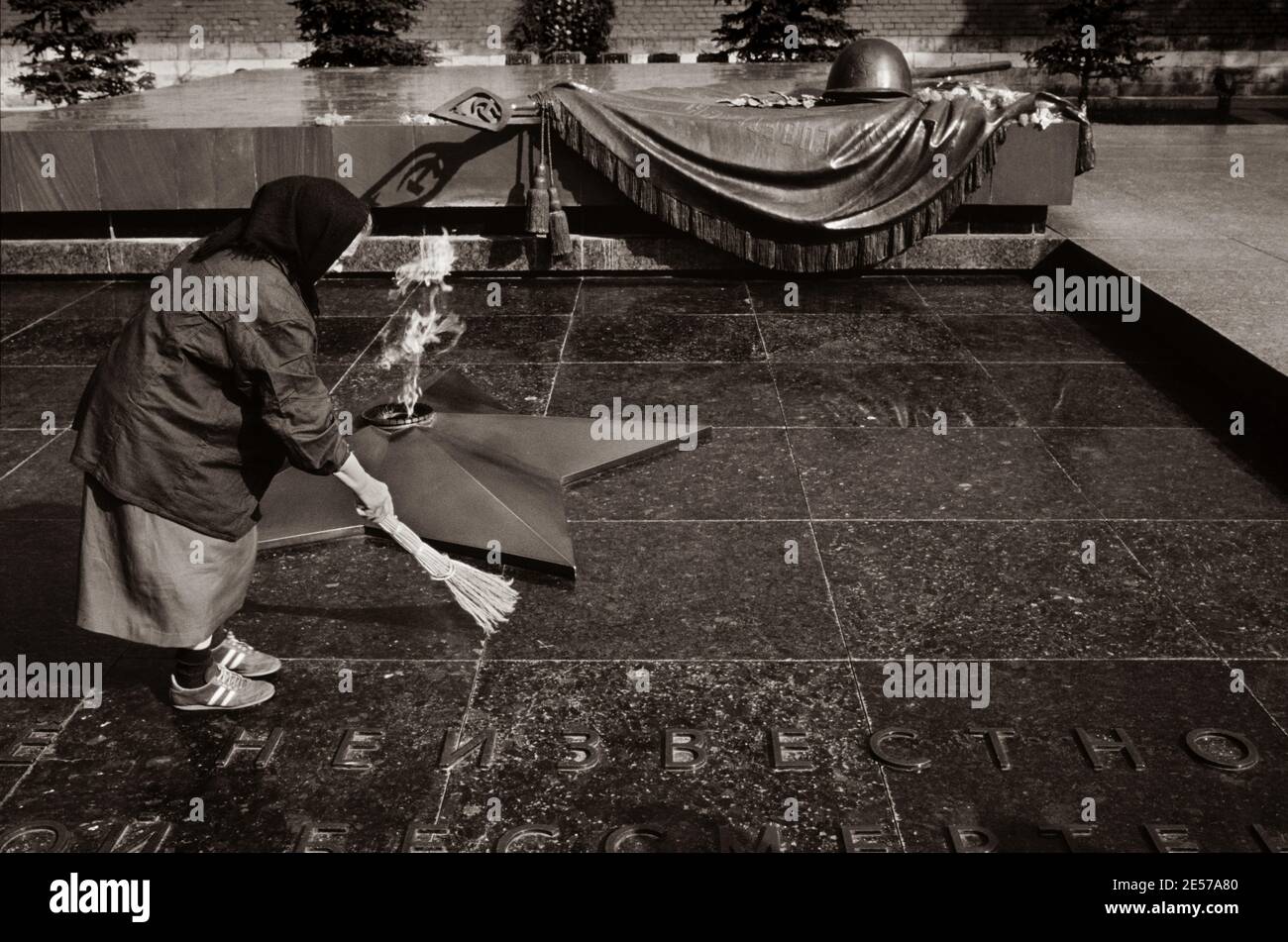 An elderly woman stoops to sweep the Tomb of the Unknown Soldier just ...