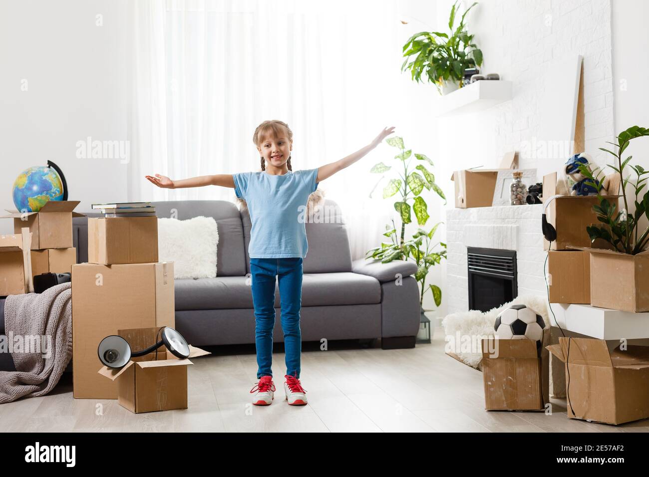 Little girl moving into new house, near cardboard box Stock Photo - Alamy