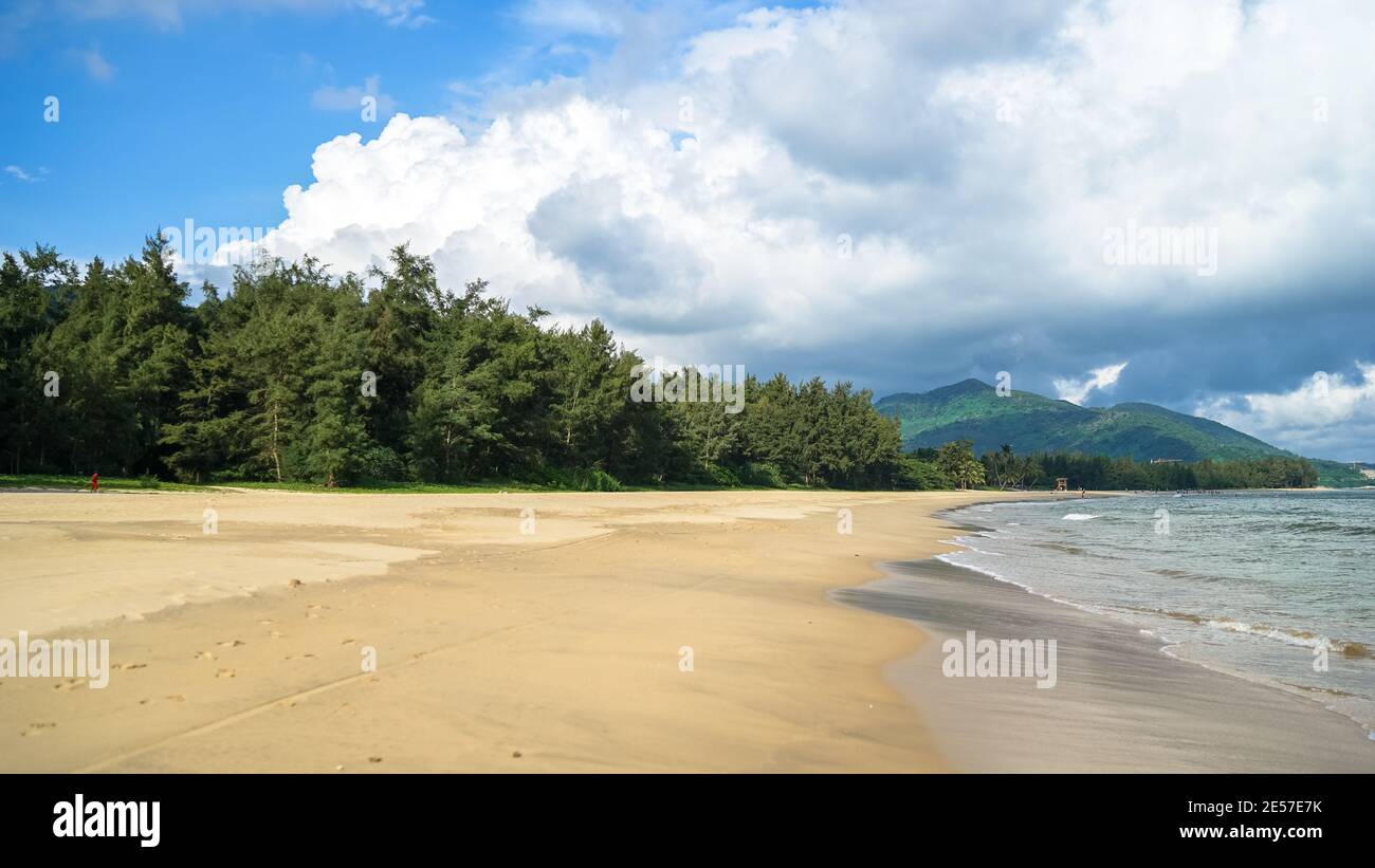 beautiful beach with white clouds and sand on Hainan Island, sunny ...