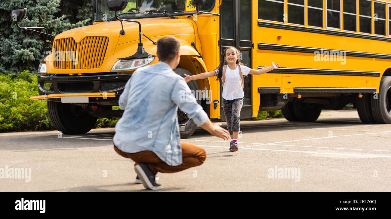 Father meeting little daughter coming out of school bus Stock Photo - Alamy