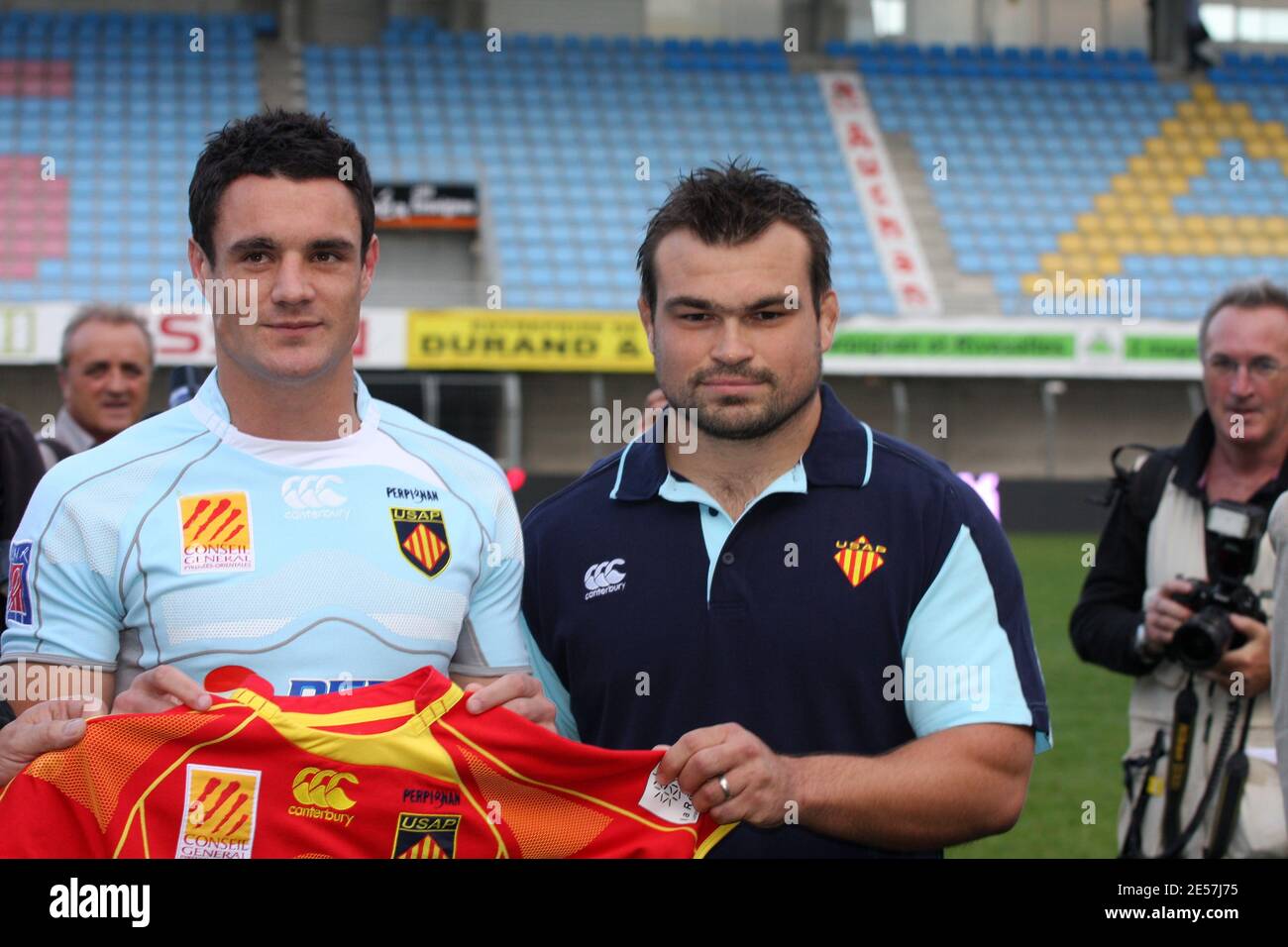 New Zealand's former All Black flyhalf Daniel Carter (L) is offered his ...