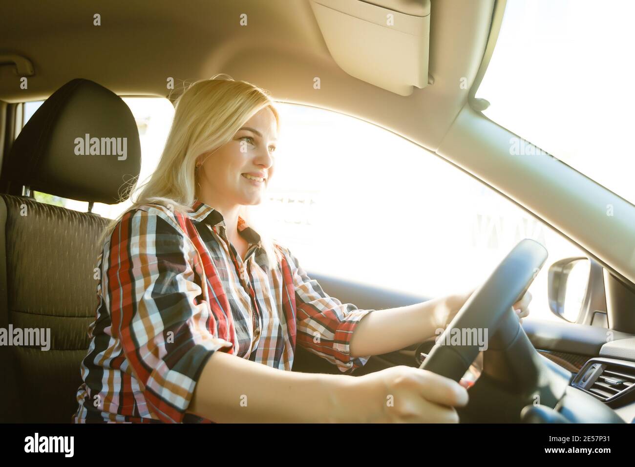 Young woman driving her car Stock Photo - Alamy