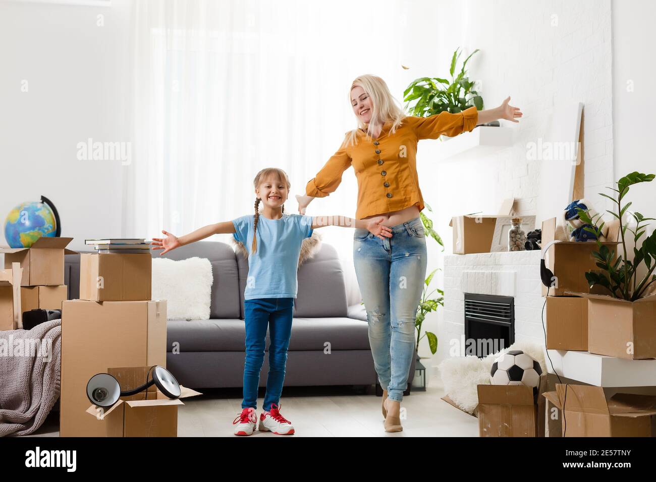 Little girl moving into new house, near cardboard box Stock Photo - Alamy