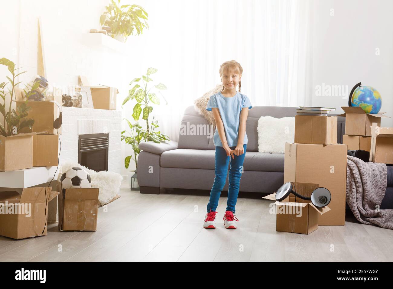 Little girl moving into new house, near cardboard box Stock Photo - Alamy