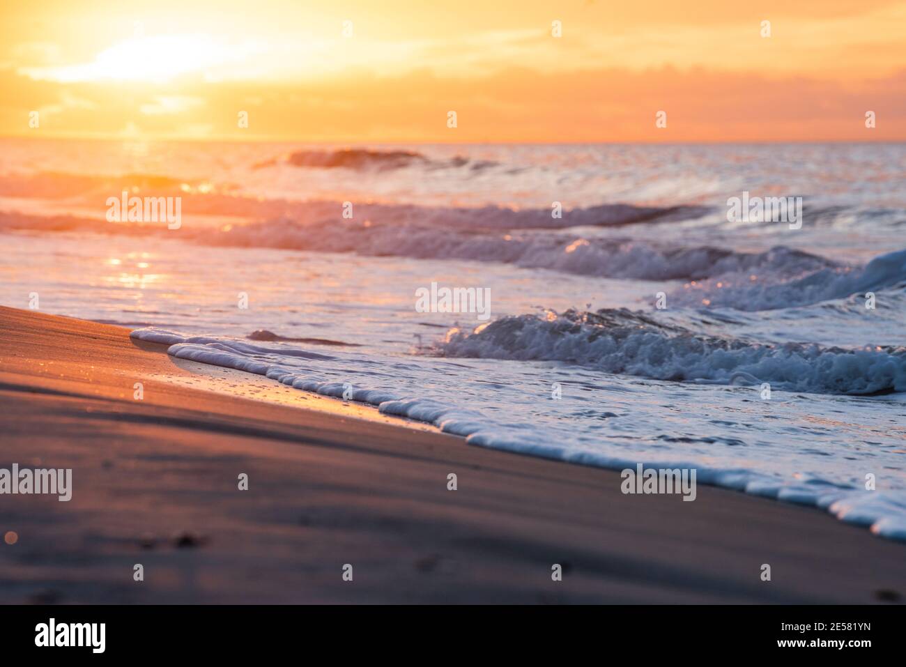 The sun glows bright orange above the Atlantic Ocean Stock Photo - Alamy