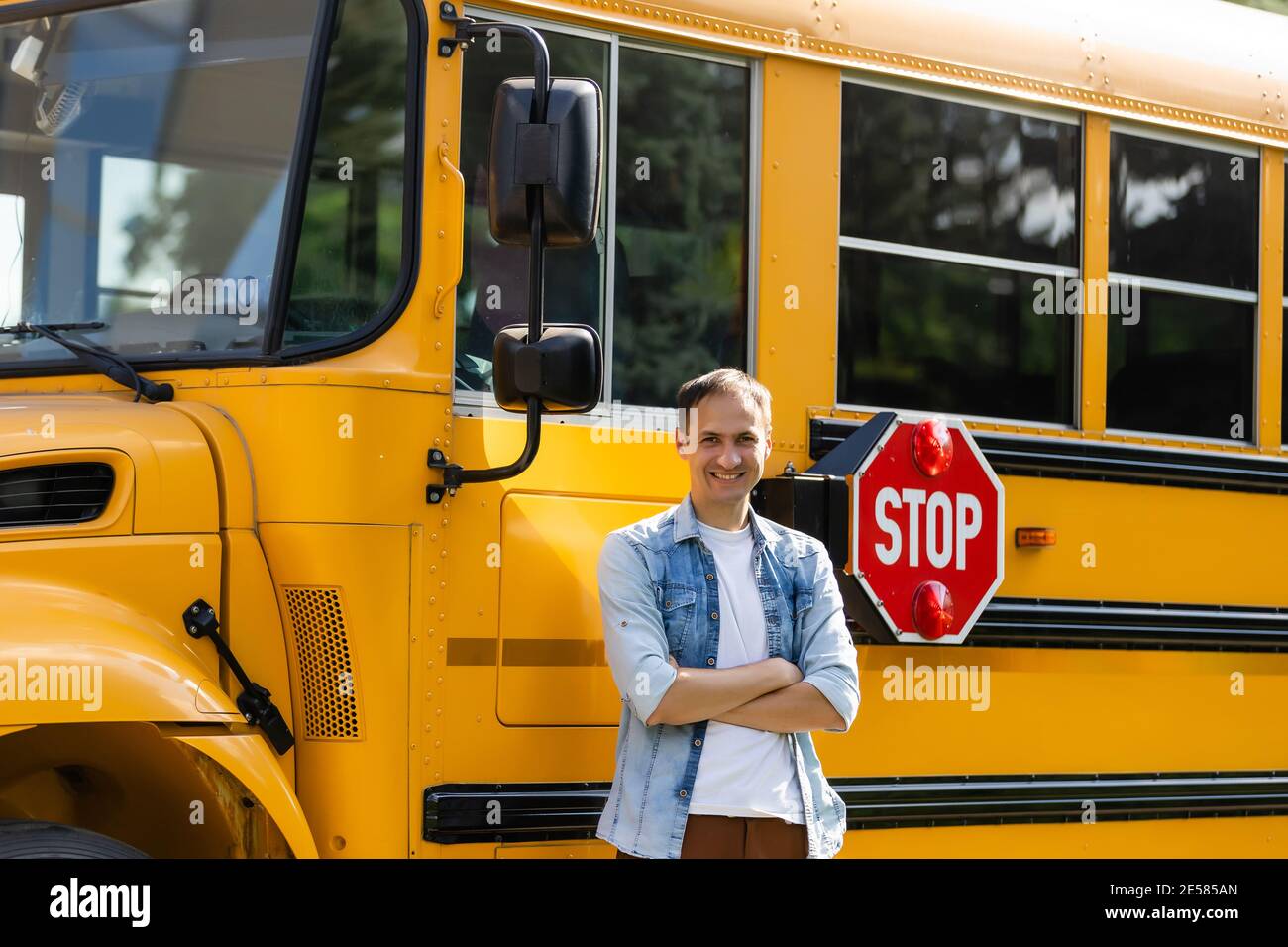 Male driver standing in front of bus Stock Photo - Alamy