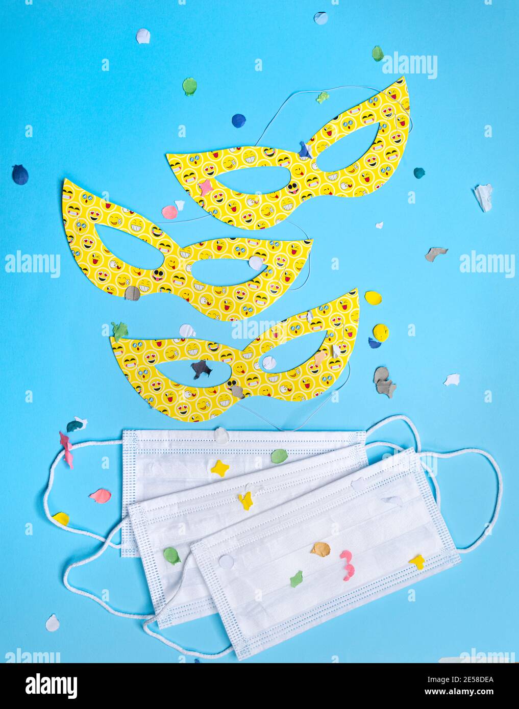 masks, confetti, treamers and mask on a colorful carnival table during ...