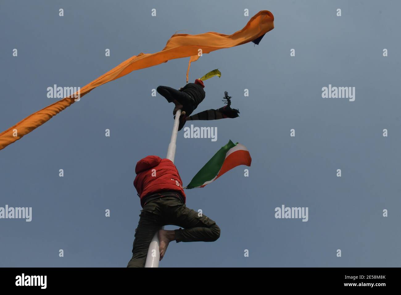 New Delhi, India. 26th Jan, 2021. Farmers trying to install their flag ...