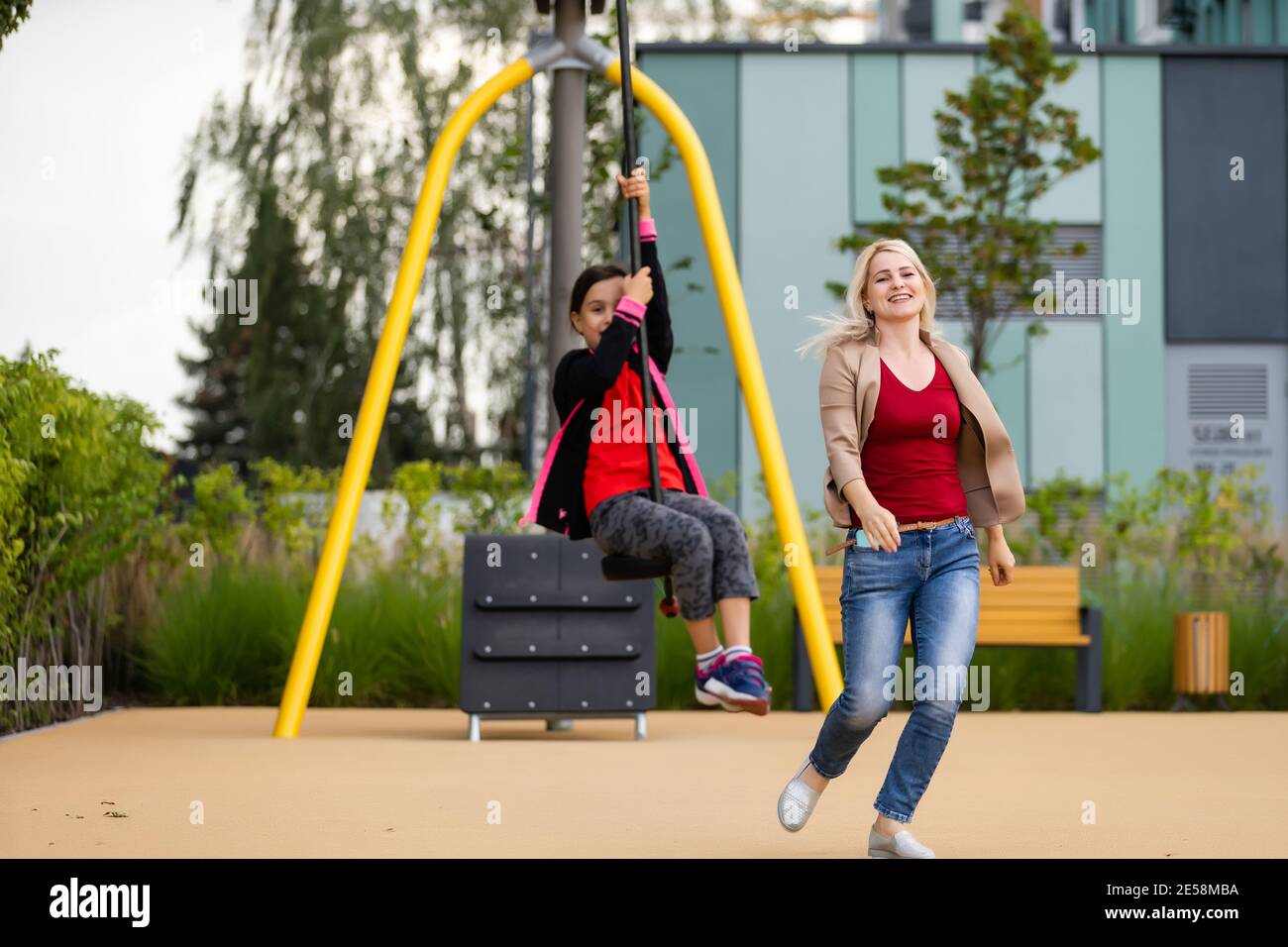 The little girl on the bungee jumping for kids outdoor Stock Photo - Alamy