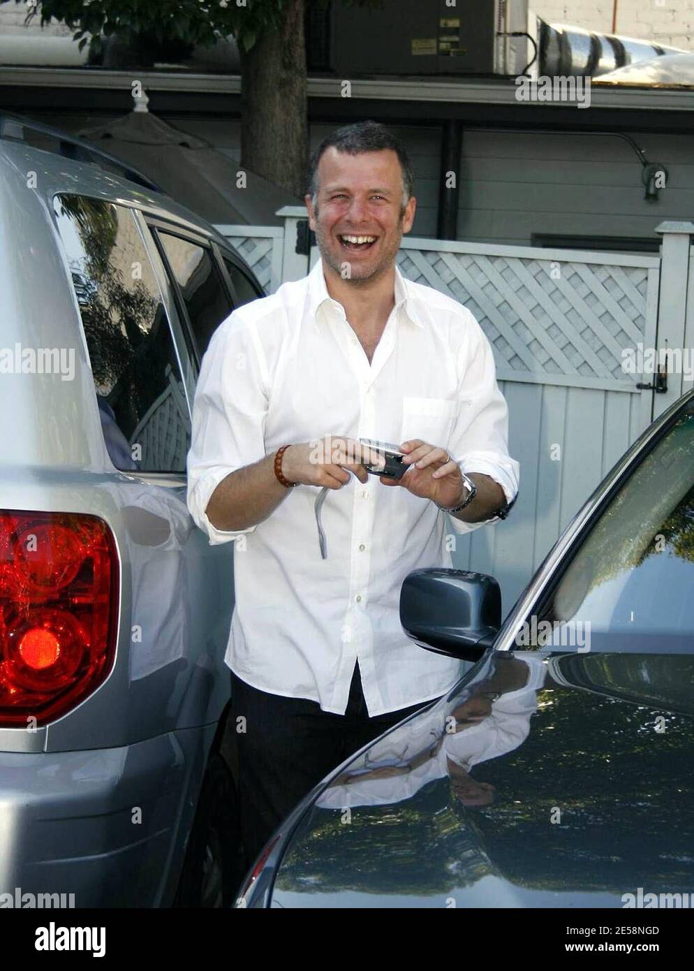 Salon owner Neil George has some fun with the paparazzi outside his ...