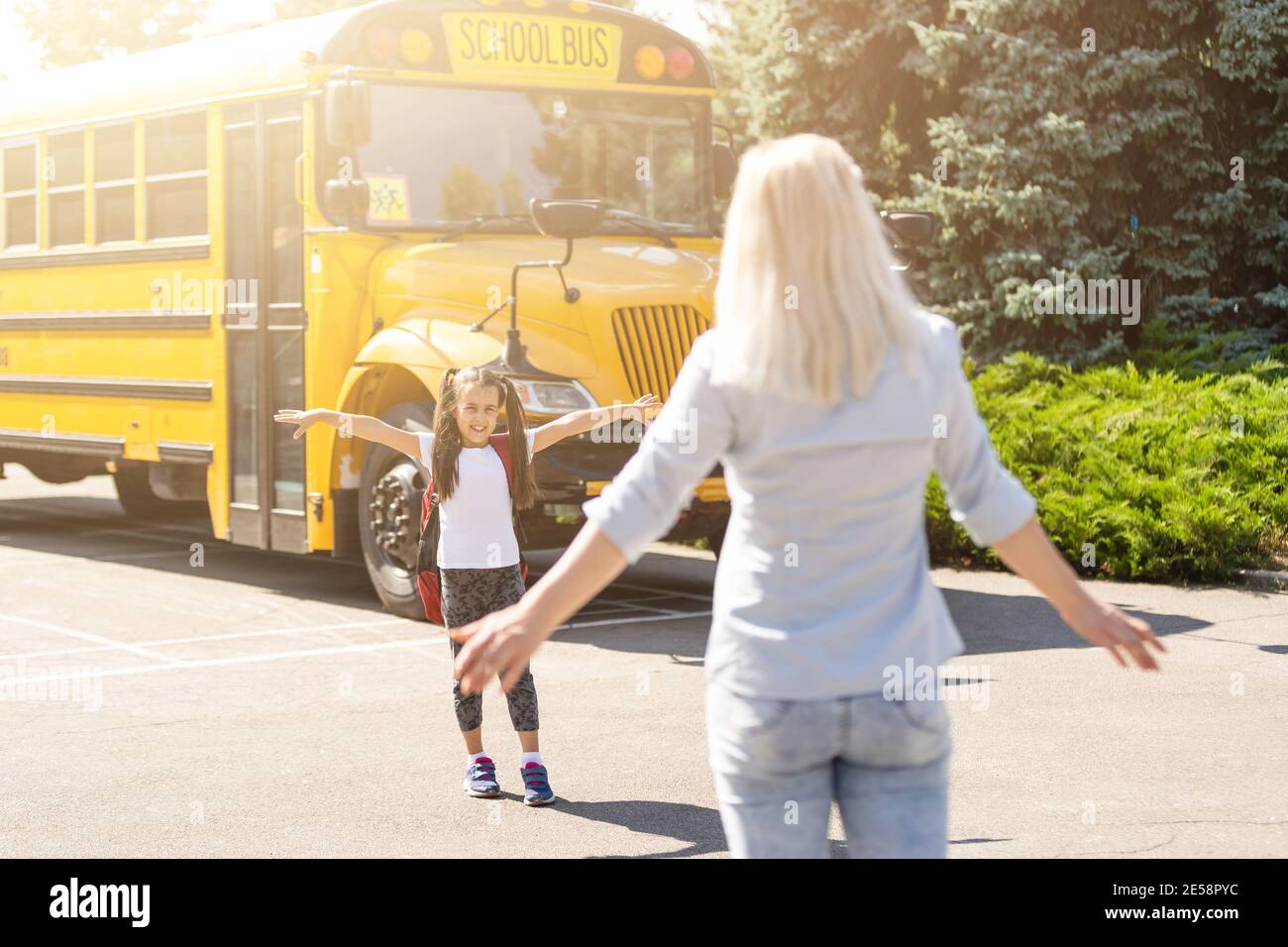 Kids student running into mother's hands to hug her after back to ...