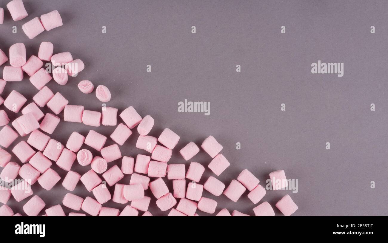 Colorful marshmallow laid out on gray paper background. pastel creative ...