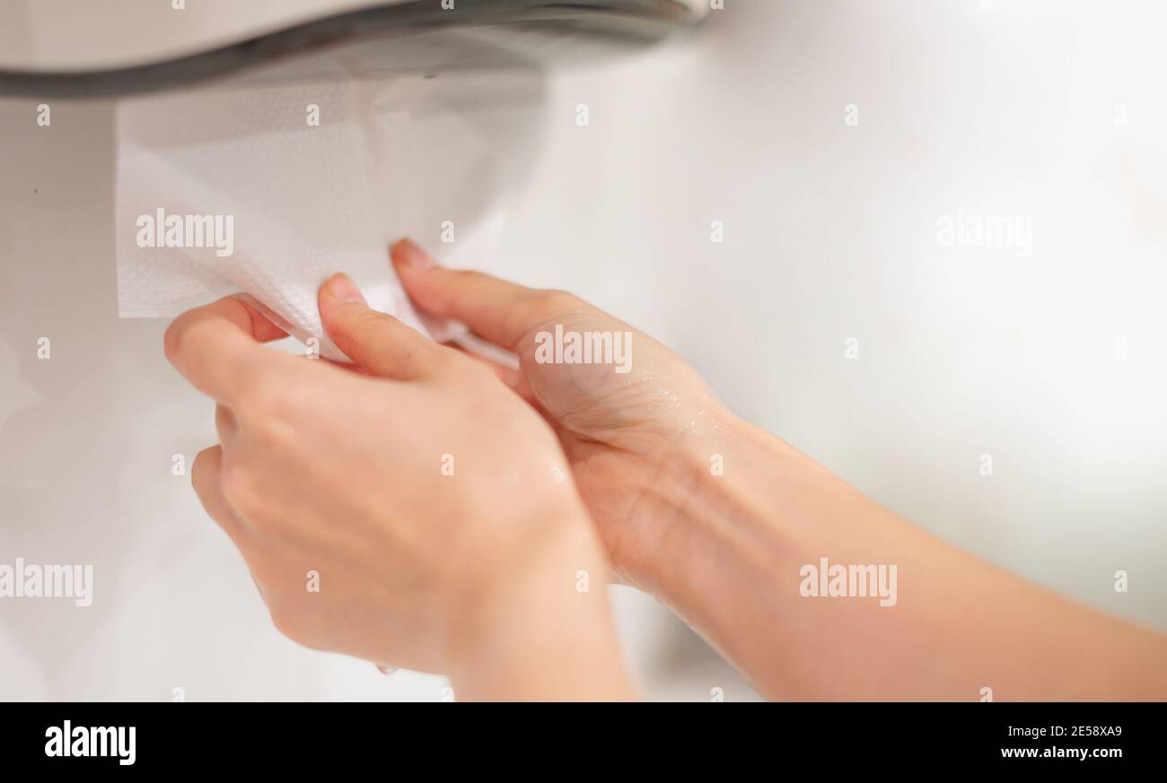 Female hand use antibacterial wet wipes or tissue after washing hand ...
