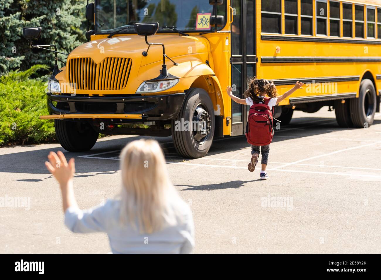 Kids student running into mother's hands to hug her after back to ...