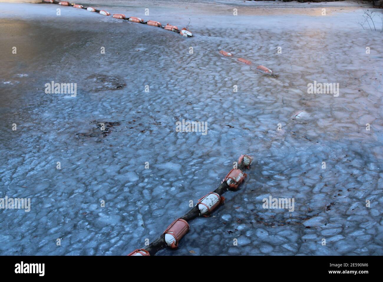 Floating marker rope partially submerged in frozen lake Stock Photo - Alamy