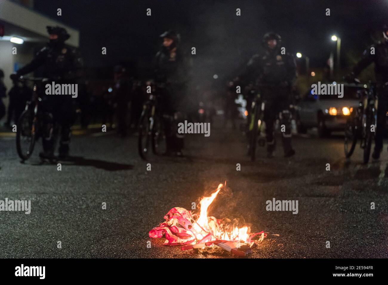 Tacoma, USA. 24th Jan, 2021. Late in the evening a burning flag at the ...