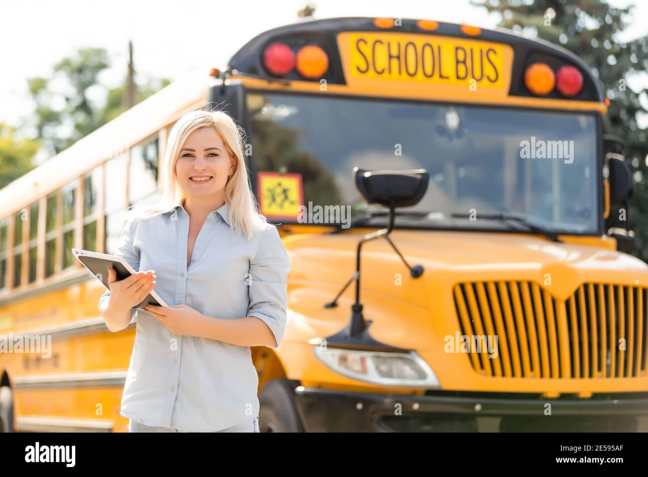 School teacher preparing kids to get on the school bus Stock Photo - Alamy