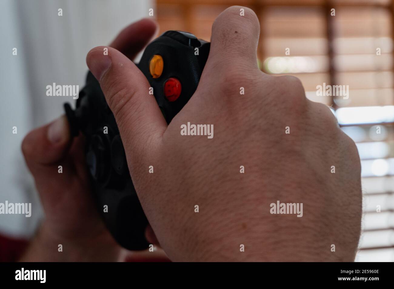 young man with a console control in his hands Stock Photo - Alamy