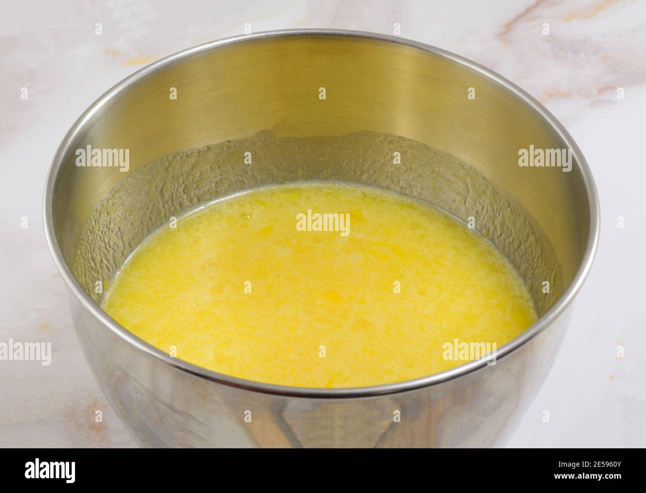 Raw lemon topping mixture for fruit bars in stainless steel mixing bowl ...