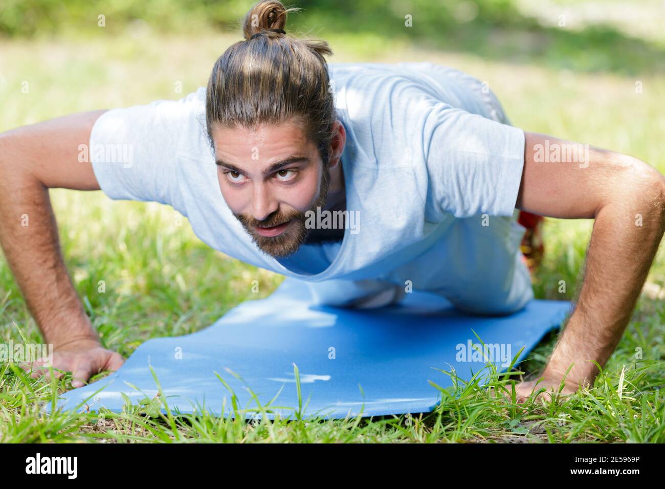 Young man in plank position hi-res stock photography and images - Alamy
