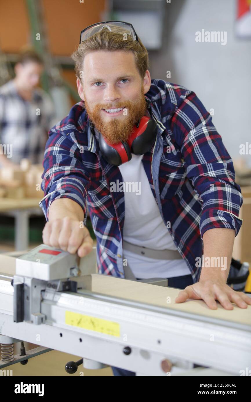 focused carpenter at work with wooden plank Stock Photo - Alamy