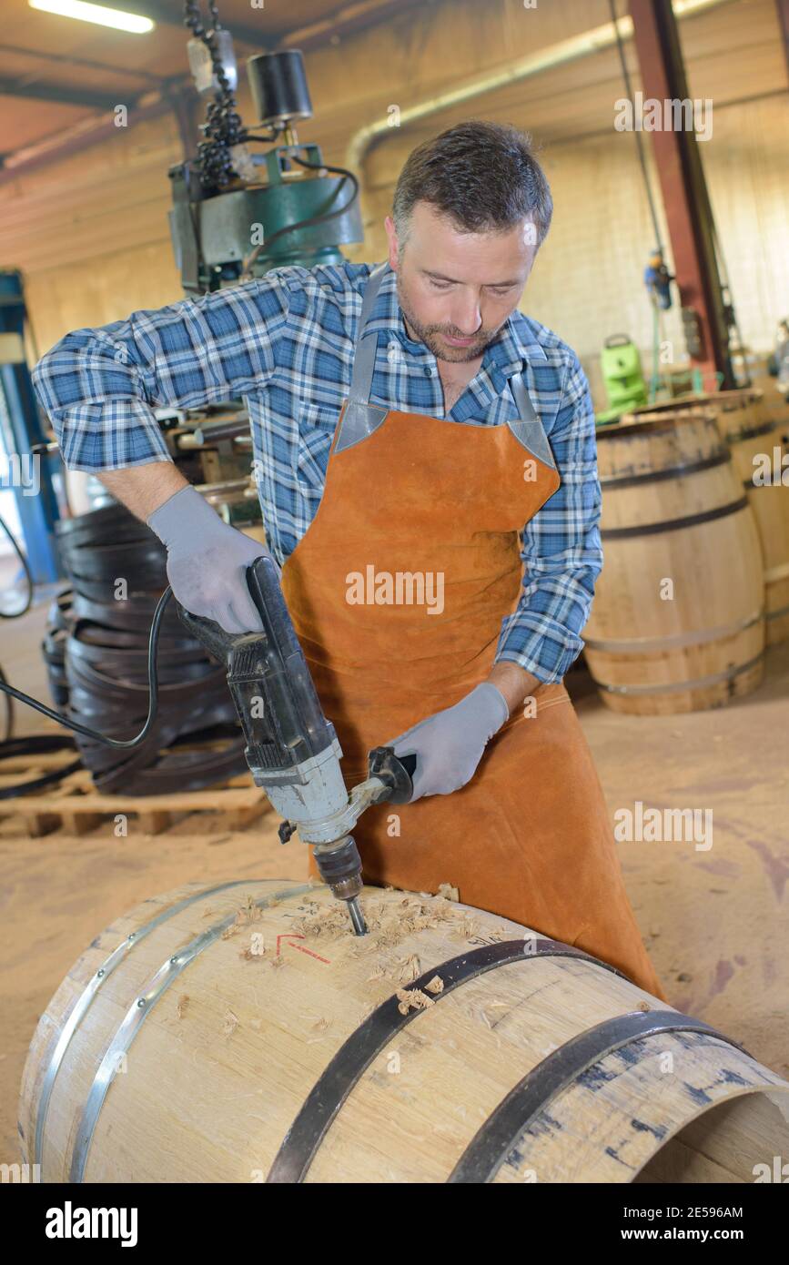 wood barrels production cooper using hammer and tools in workshop Stock ...