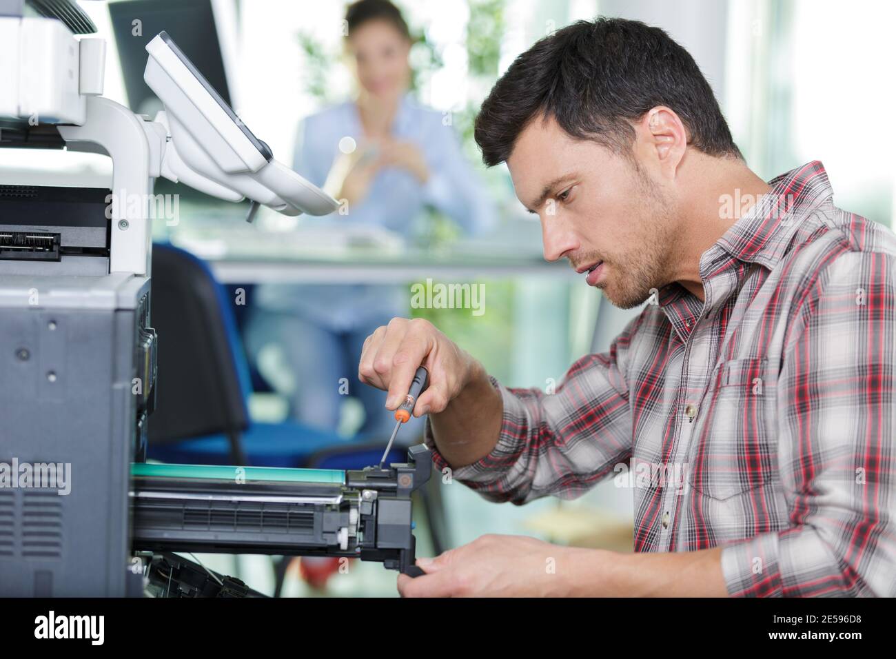 a man is fixing printer Stock Photo - Alamy
