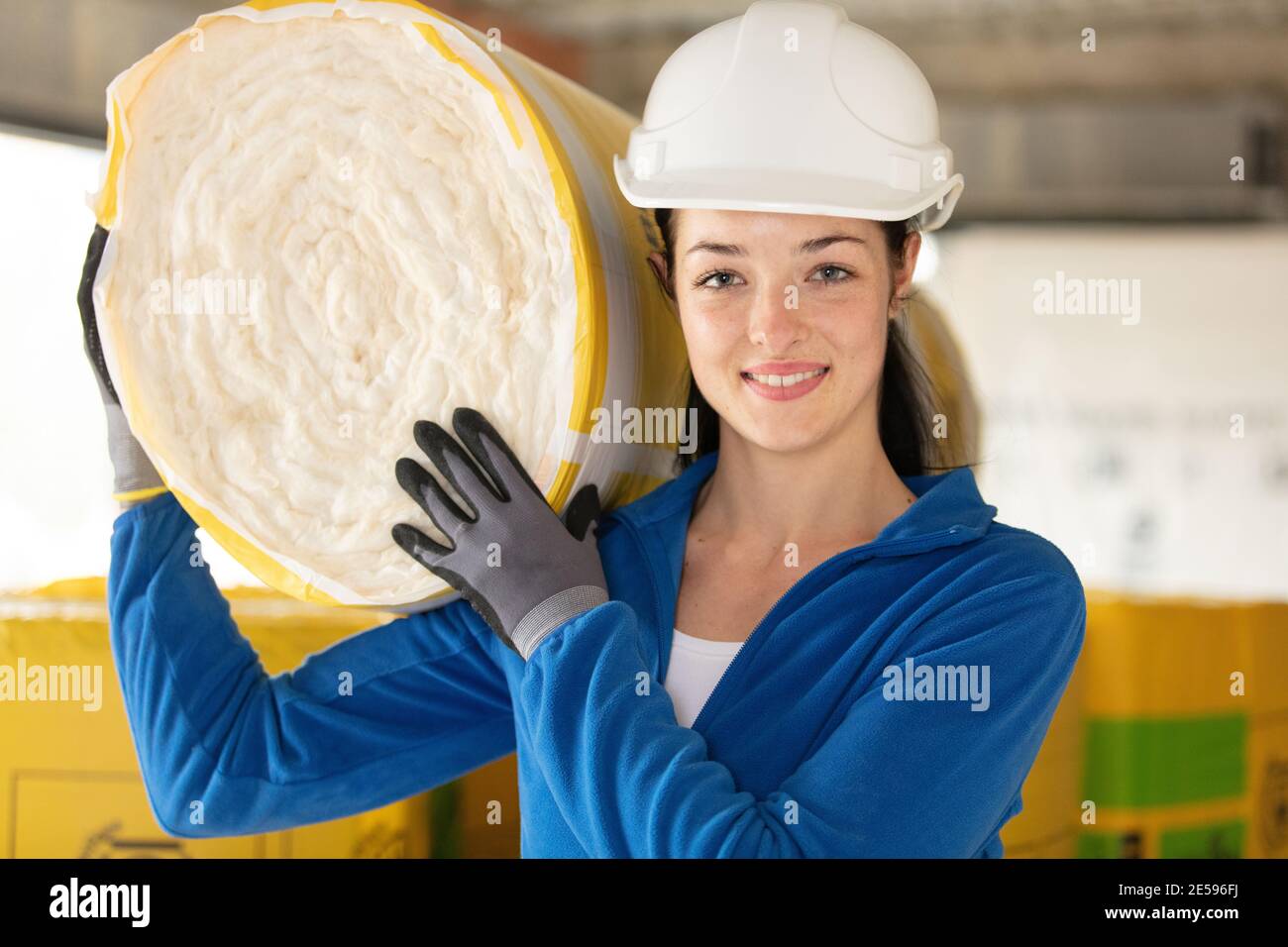 woman builder carrying insulant roll Stock Photo - Alamy