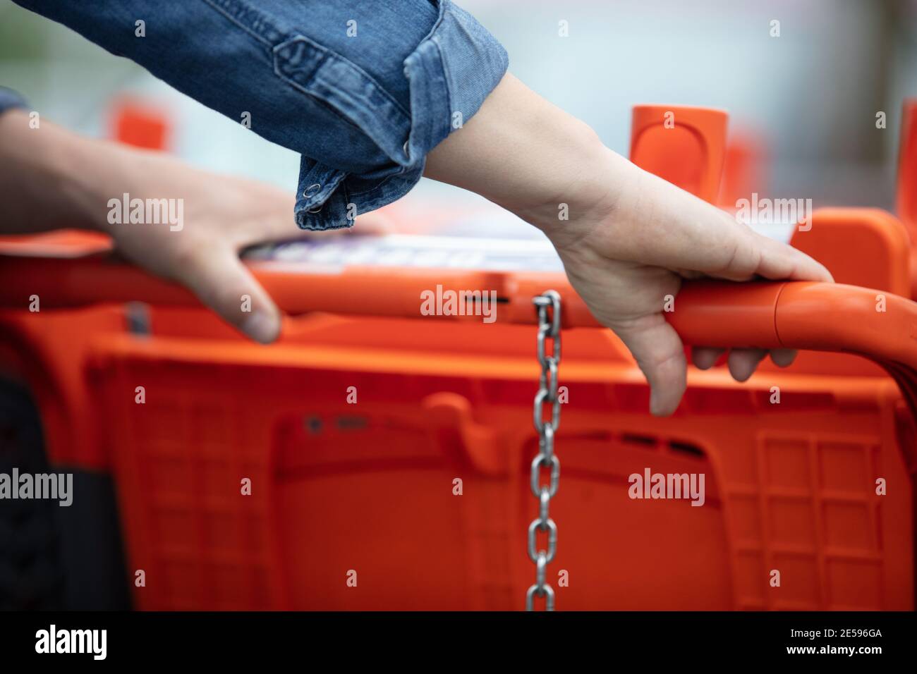 woman pushing shopping cart in store Stock Photo - Alamy
