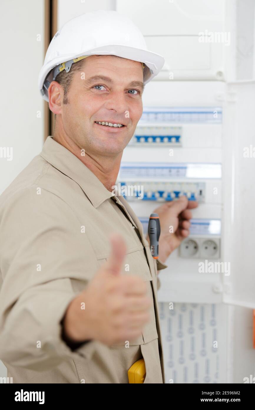 portrait of electrician standing next to fuseboard Stock Photo - Alamy