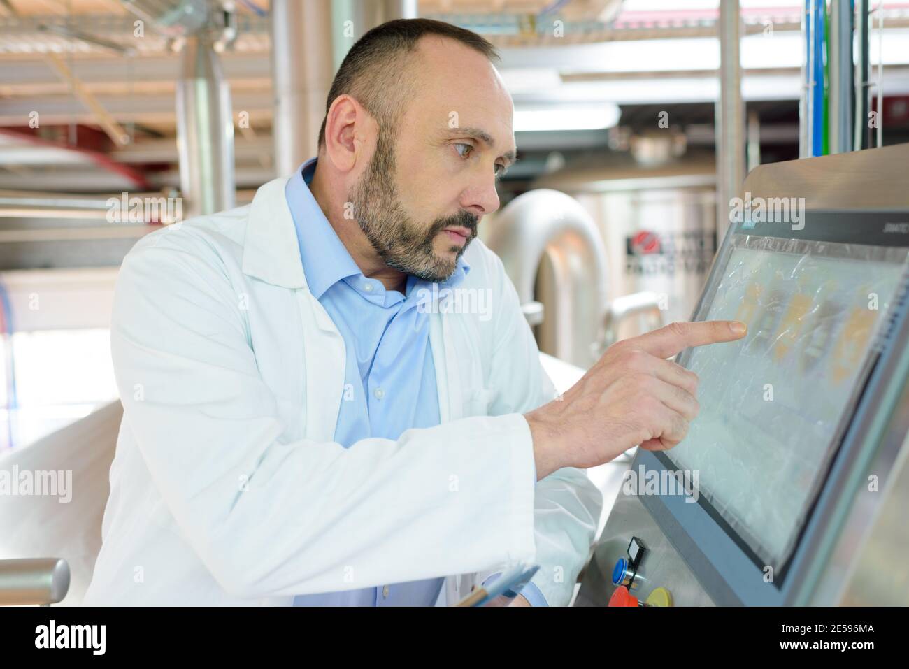 worker checking results in screen Stock Photo - Alamy