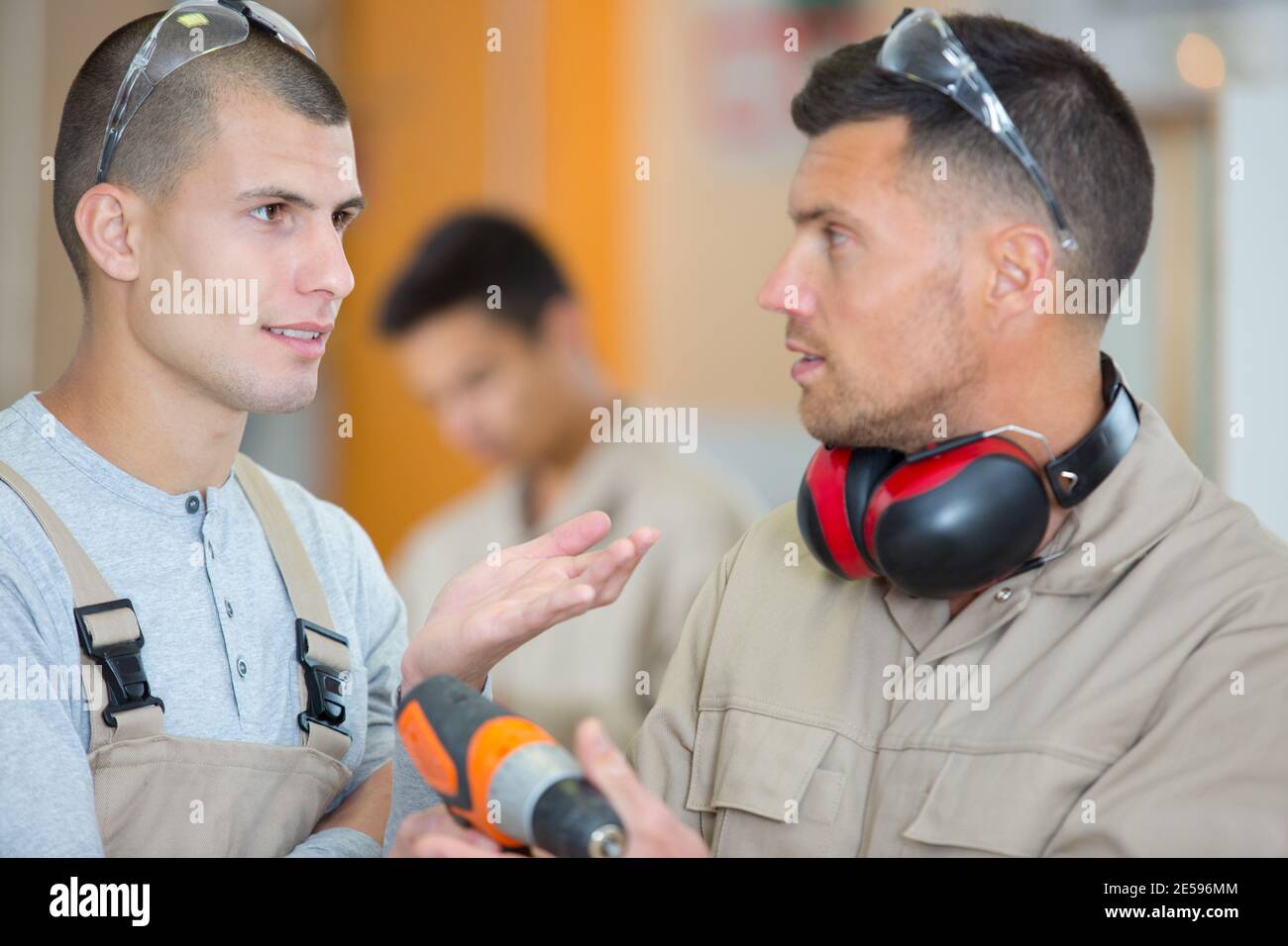 two workers having a conversation Stock Photo - Alamy