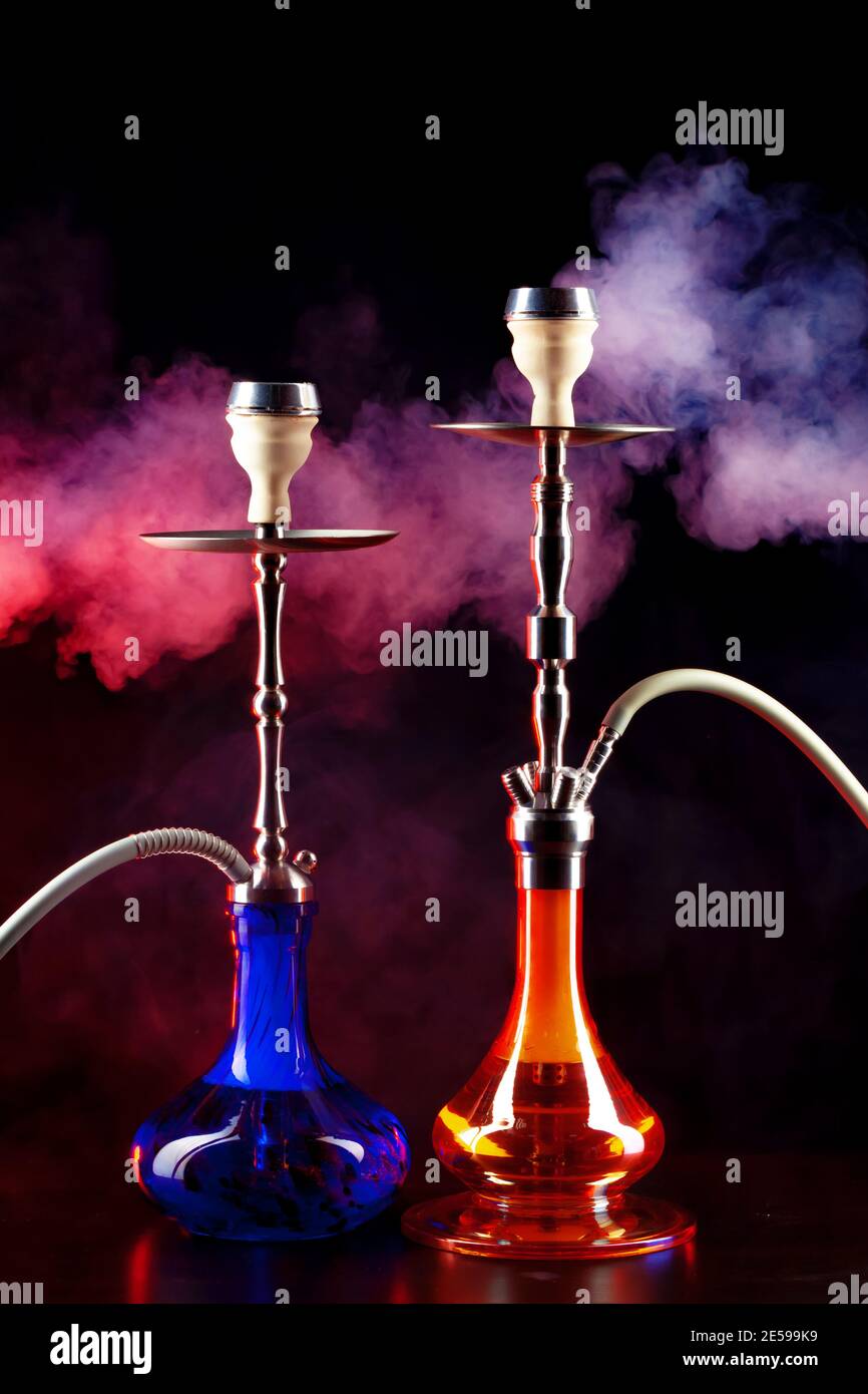Modern hookah with smoke in dark club light Stock Photo - Alamy