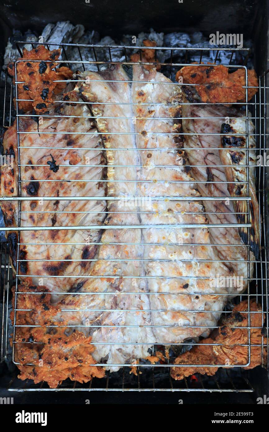 Cooking of fish with caviar on a barbecue grill Stock Photo - Alamy